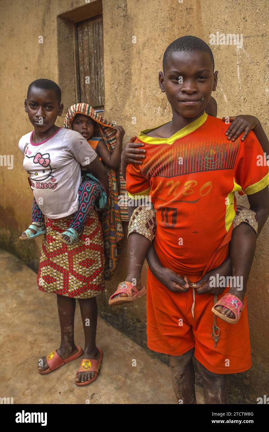 Brother and sister carrying their siblings on their backs in a southern ...