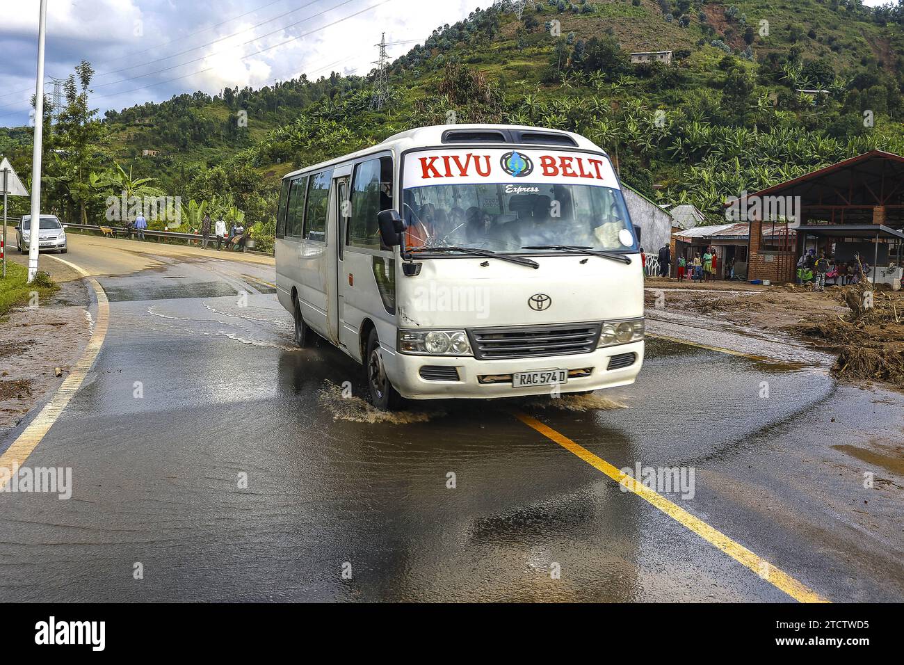 Bus on a road flooded and damaged by mudslides in western province ...