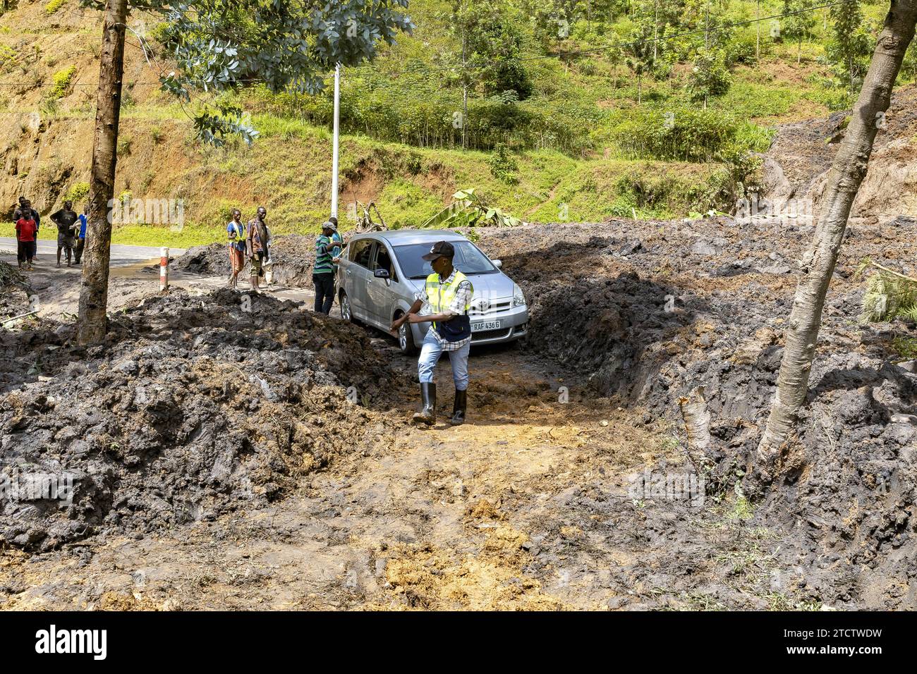 Muddy pathway along a road blocked by mudslides in western province ...