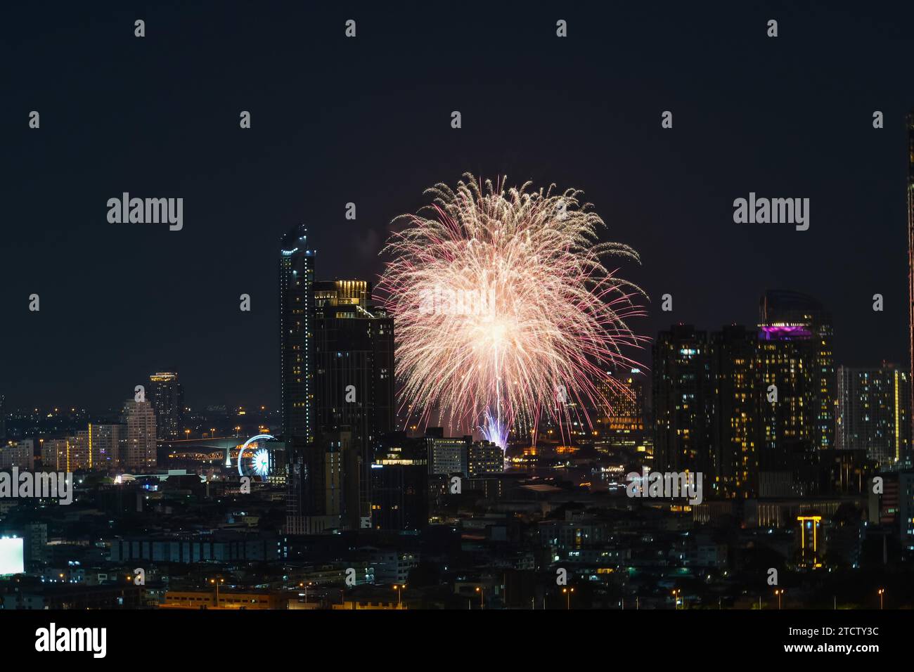 View of fireworks fireworks sparks explosions in the sky among tall ...