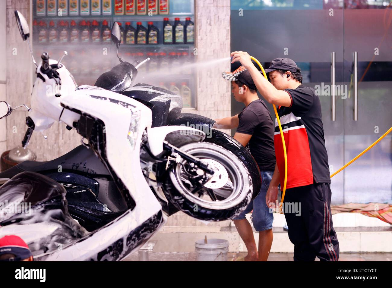 Washing scooter vietnam hi-res stock photography and images - Alamy
