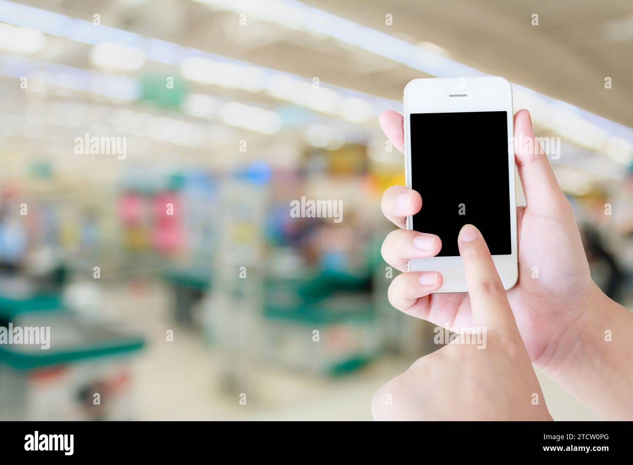 Hand use smartphone with Supermarket store background ,Cashier counter ...