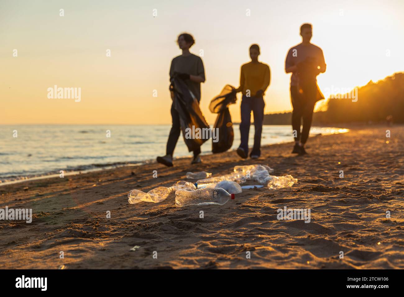 Earth day. Volunteers activists team collects garbage cleaning of beach ...