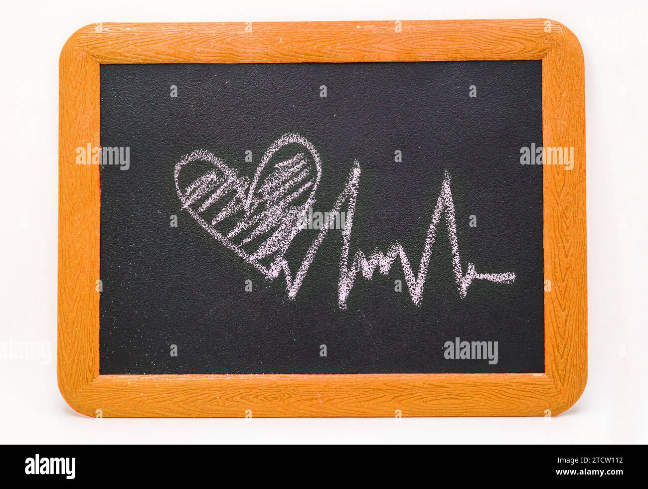 Heartbeat sign, love heart on a chalkboard isolated on white background ...