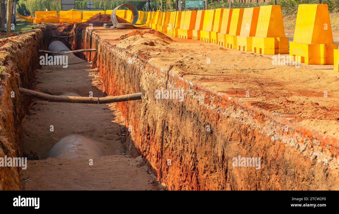 Construction new steel water pipe layout underground earthwork trench earthworks close-up ...