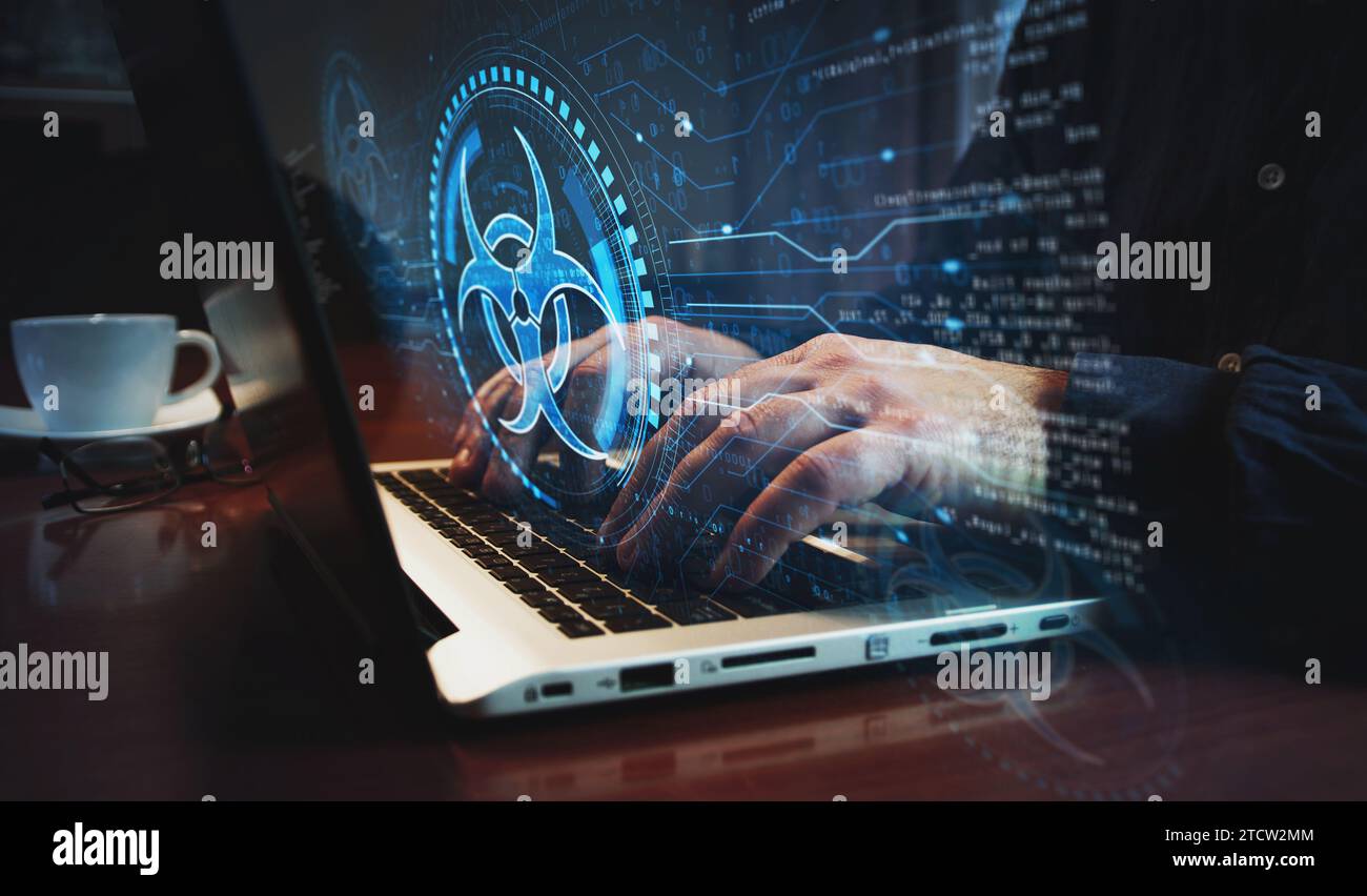 Biohazard danger alert and virus warning symbol and man typing computer ...