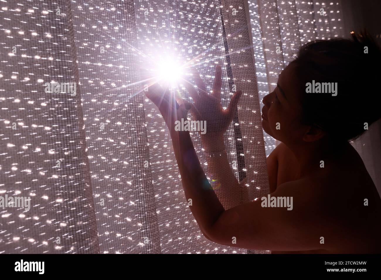Woman praying against a window with sun rays Stock Photo - Alamy