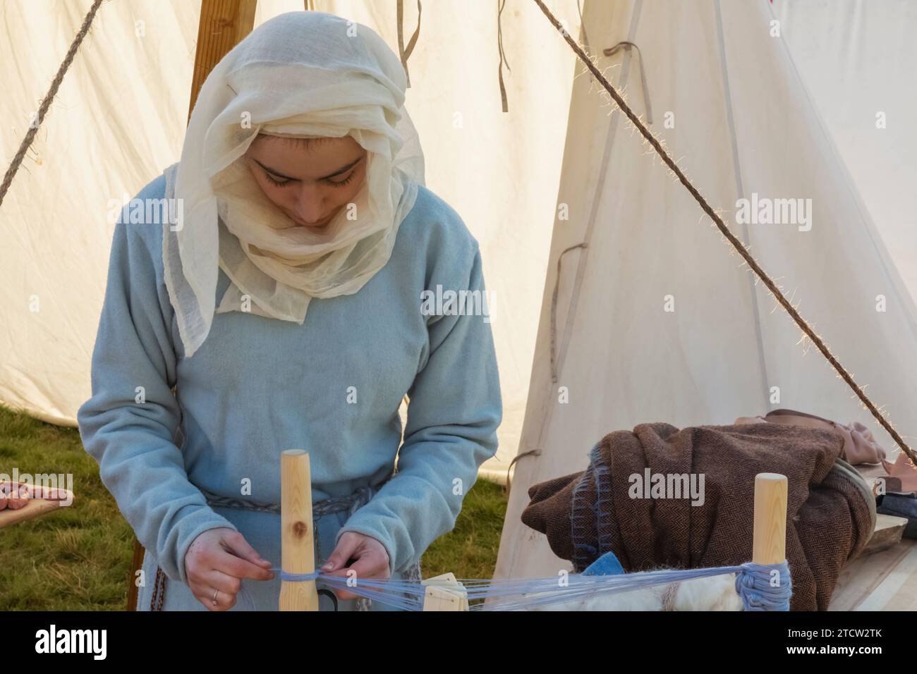 Woman in medieval costume spinning wool hi-res stock photography and ...