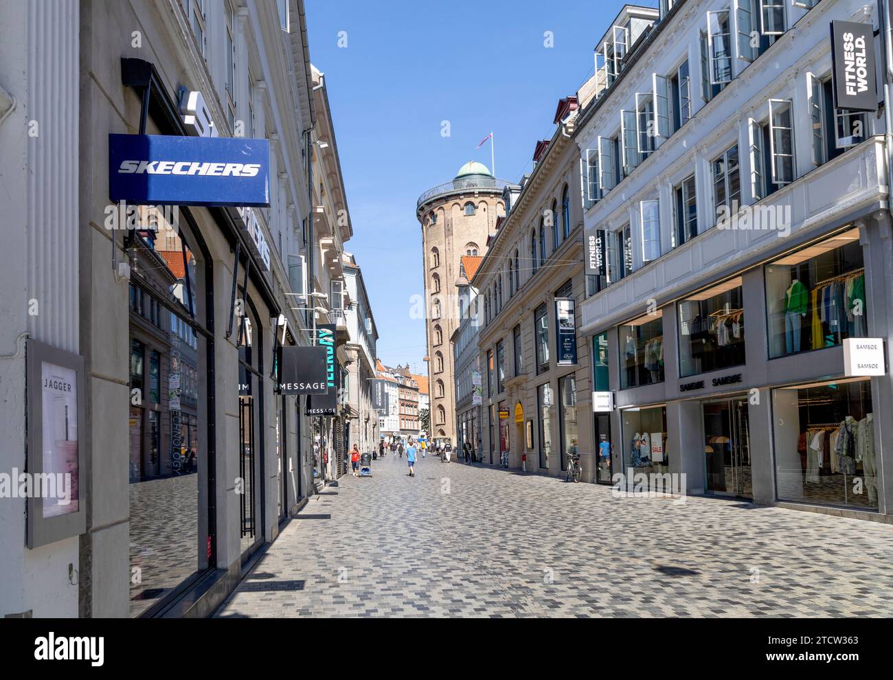 Downtown Copenhagen with old houses and store signs on a sunny day ...