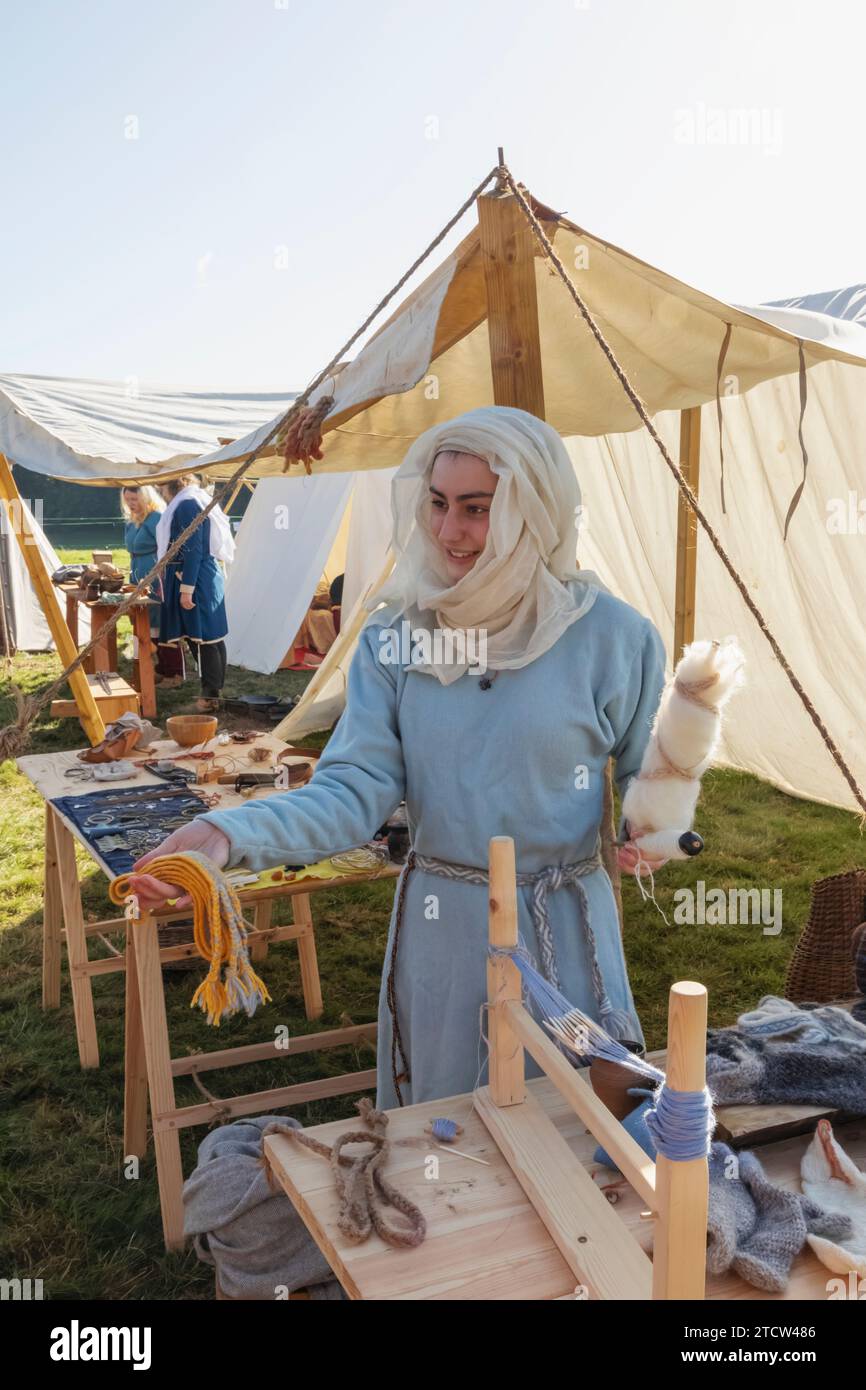 Woman in medieval costume spinning wool hi-res stock photography and ...