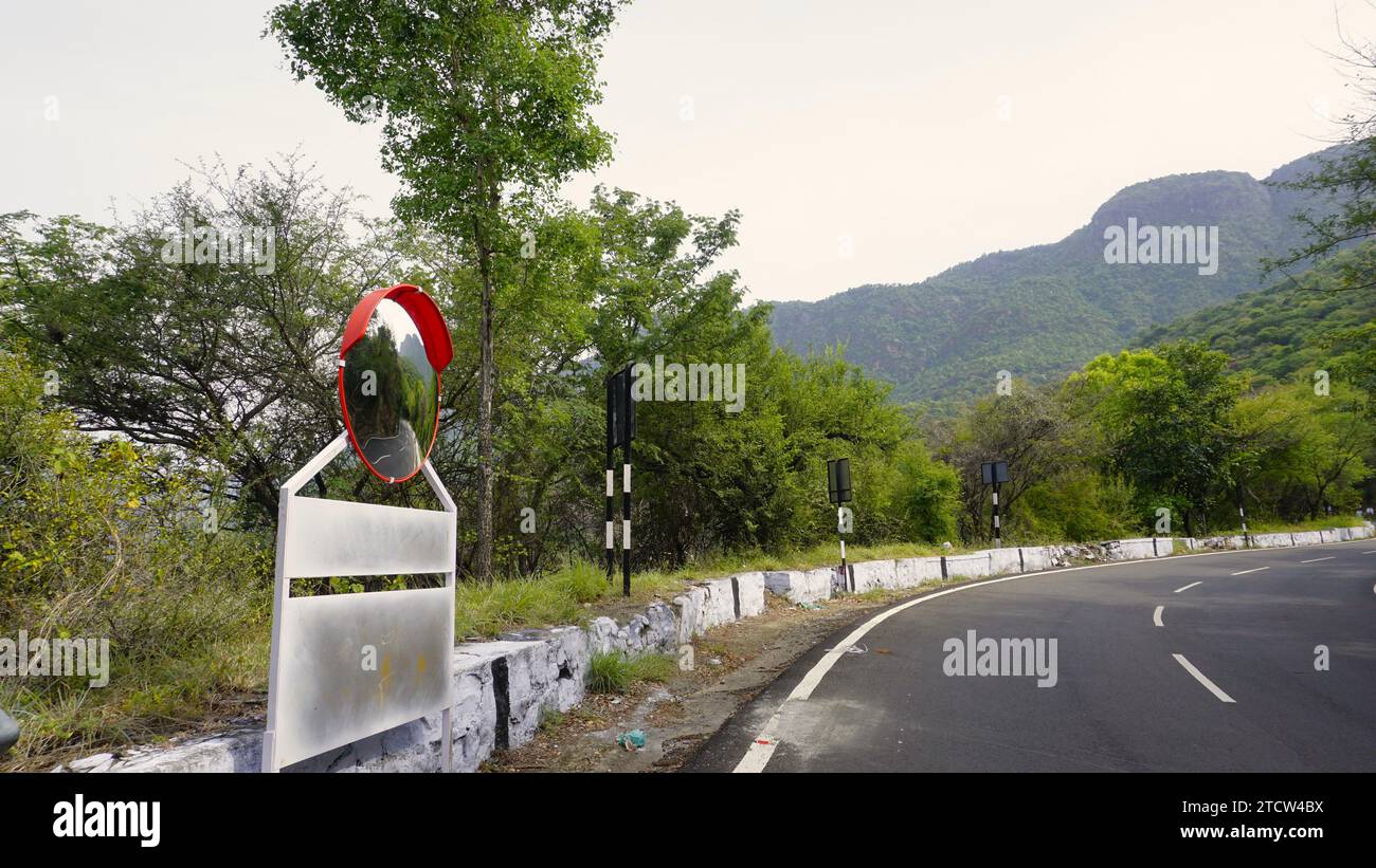 Outdoor traffic convex mirror in the hairpin bends and uphill road ...