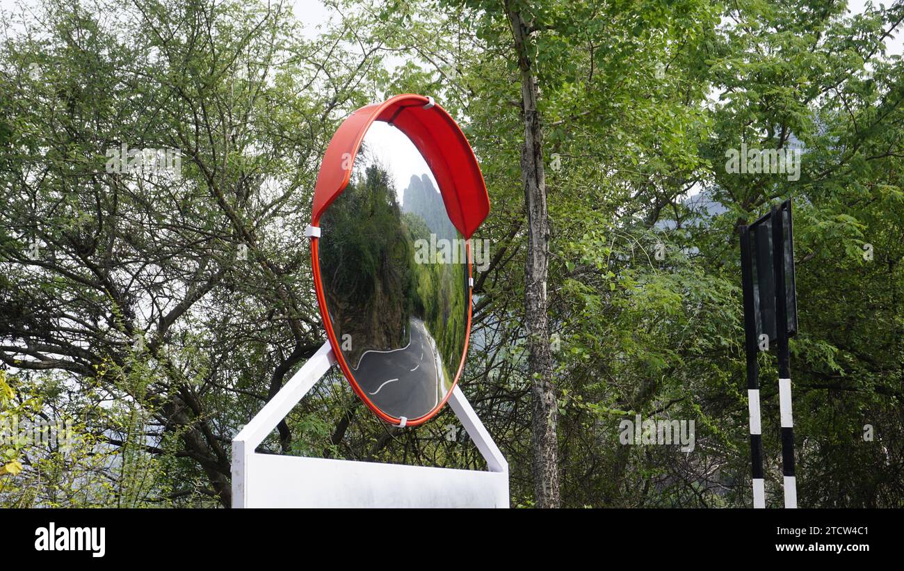 Outdoor traffic convex mirror in the hairpin bends and uphill road ...