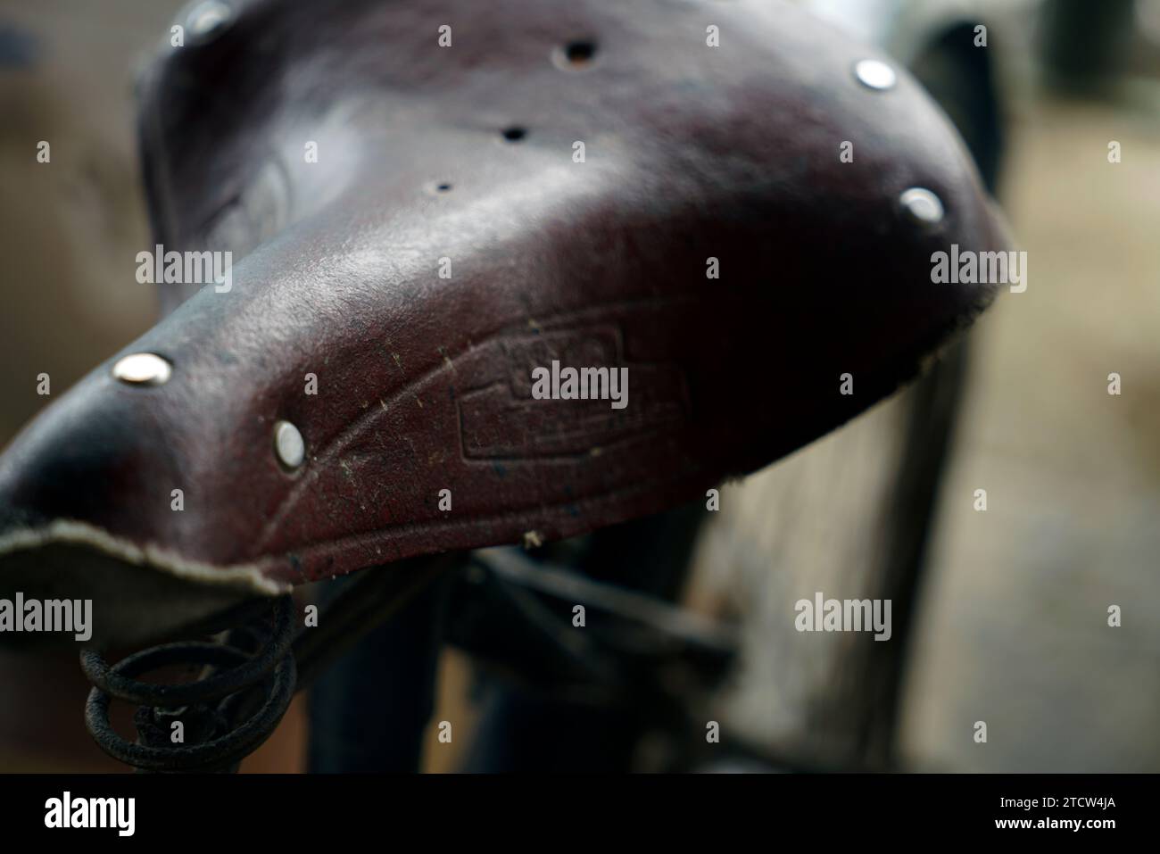 Close-up view of an old bicycle seat on a metal rod with connected ...