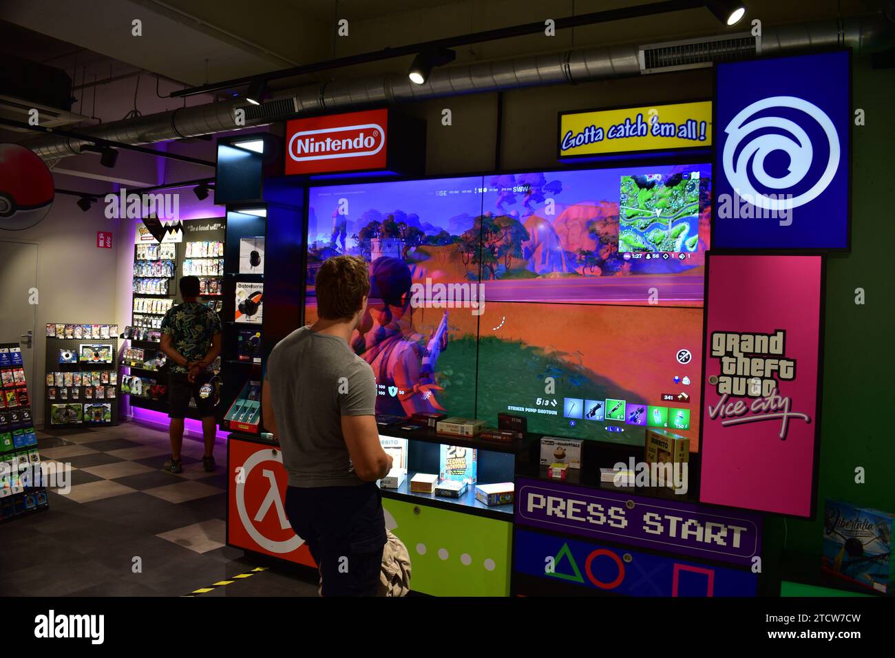 Young man playing Fortnite inside the video game store "Game Mania" in ...
