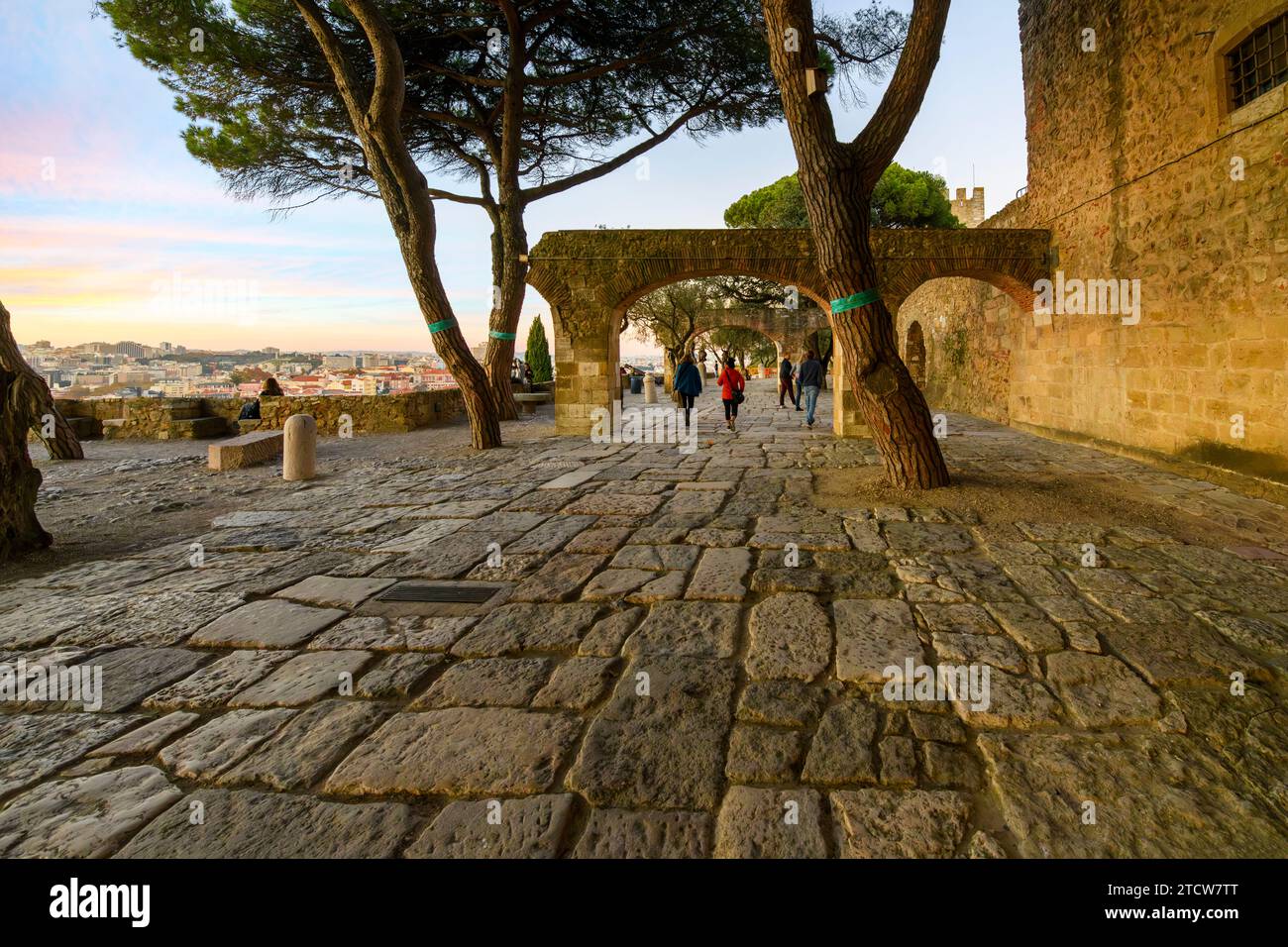 Visitors walk a terrace of Saint George's Castle or São Jorge Castle ...