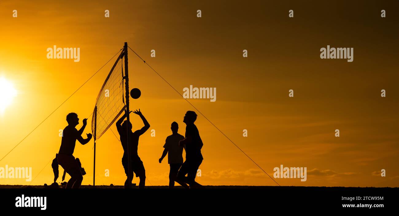 People Playing Volleyball by the Ocean at Sunset Stock Photo - Alamy