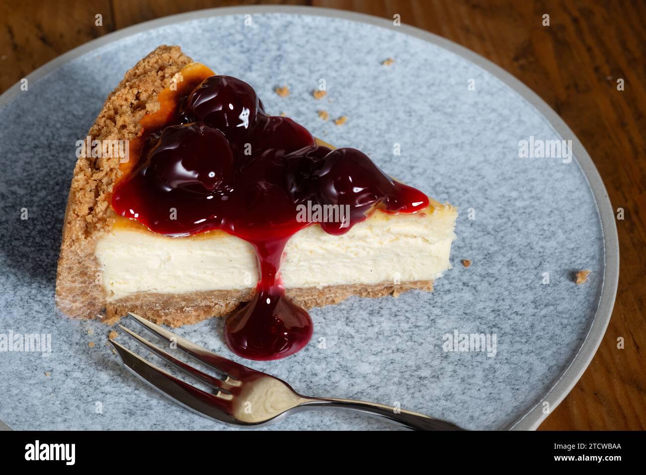 A sliced single portion of a deep filled New York style Cheesecake ...