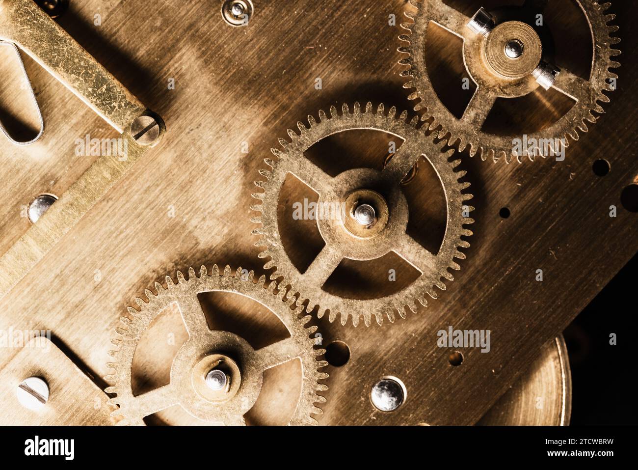 Gears made of brass are on a backside of a table clock. Vintage clock ...