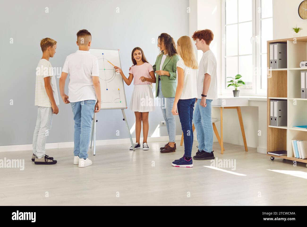 Group of school children giving their presentations by the board in the ...