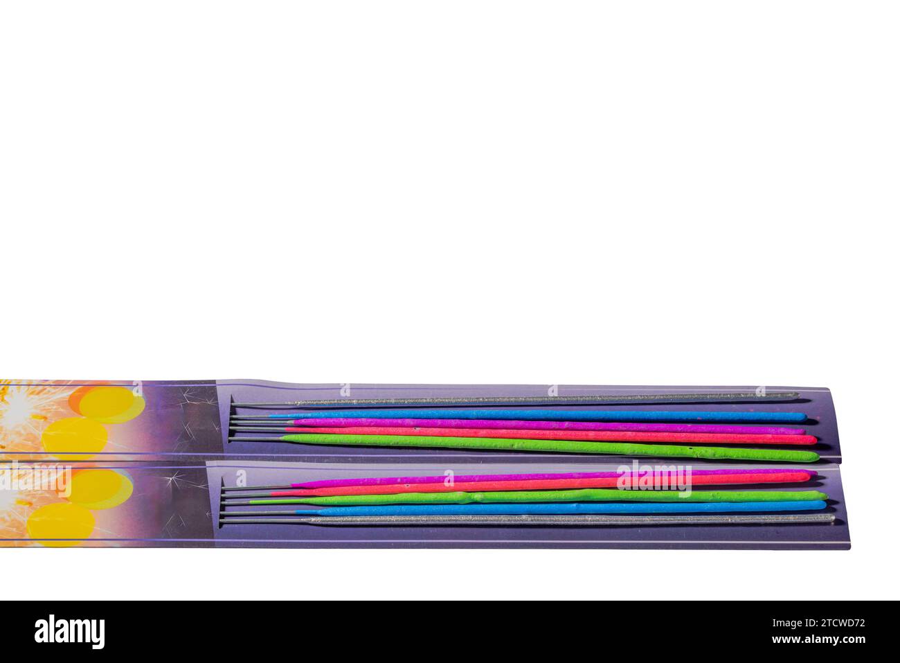 Close-up view of colorful sparklers set against a white background ...