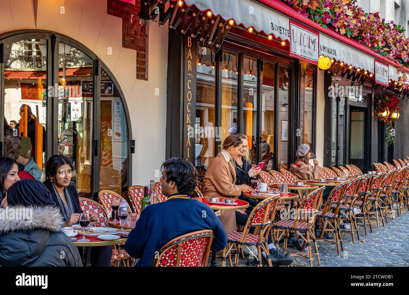 People sitting outside enjoying a drink at La Bohème Montmartre ,a ...