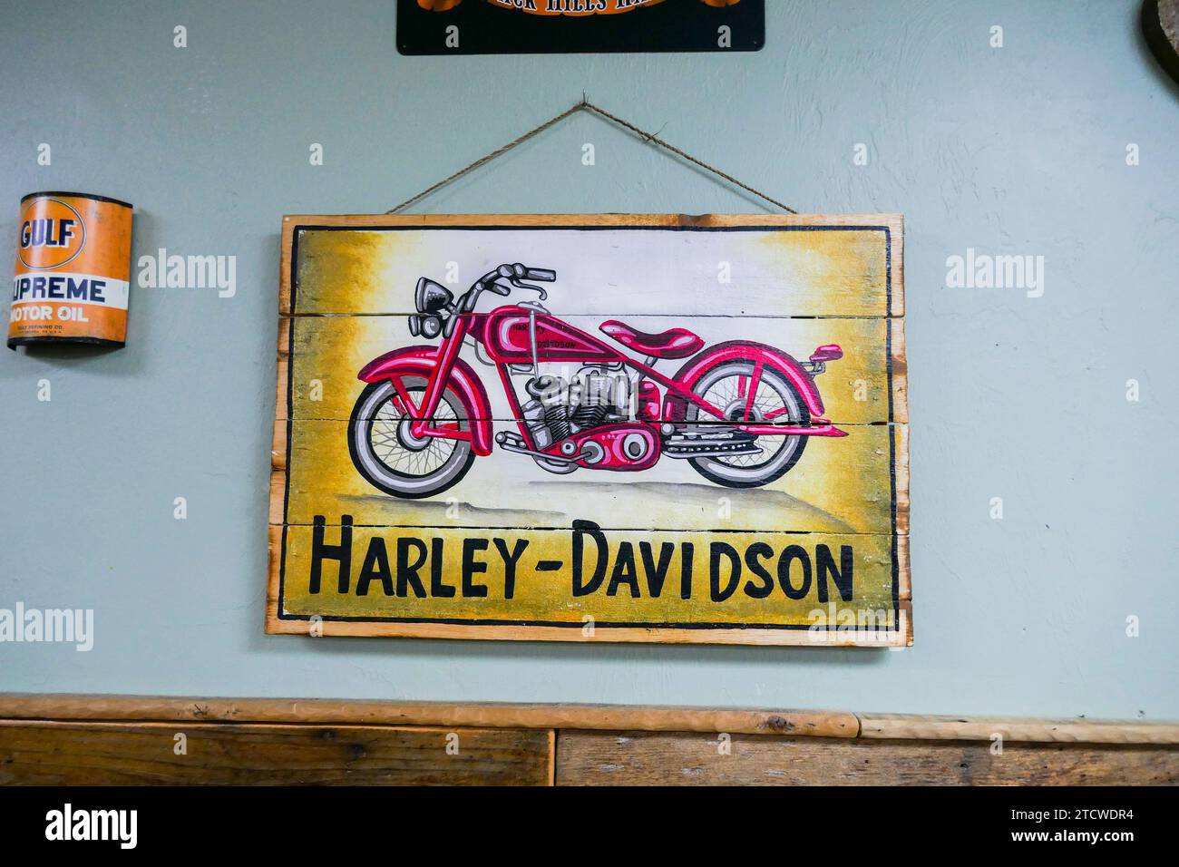 Wall plaque featuring the image of a Harley Davidson motorcycle hangs ...