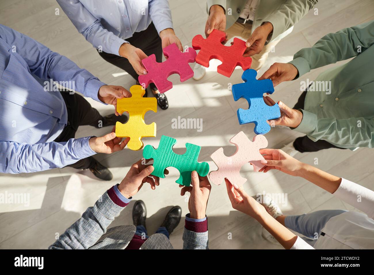 Business team showing concept teamwork by connecting colorful parts of ...