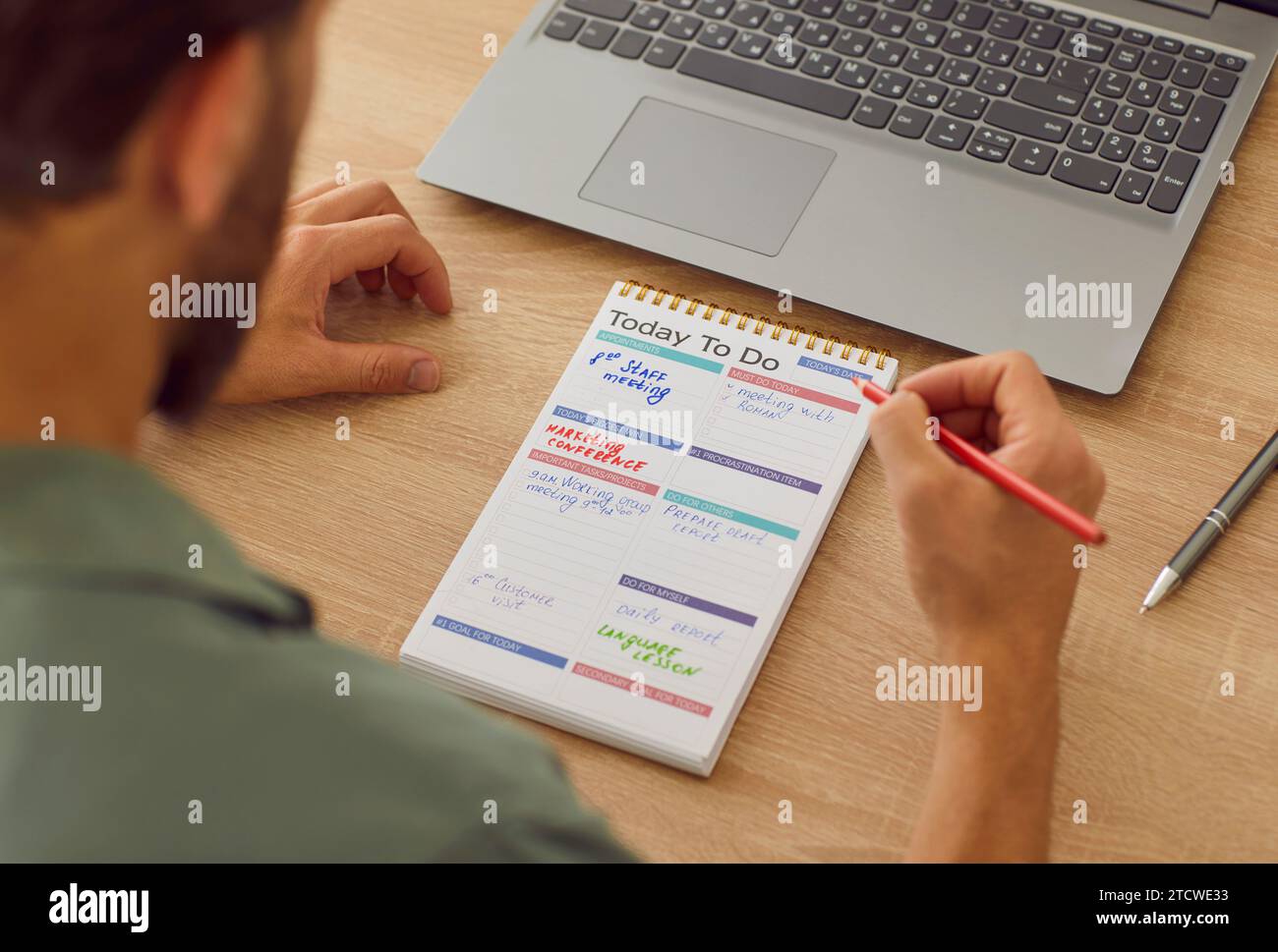 Rear View of Man Writing To Do List with Pencil Stock Photo - Alamy