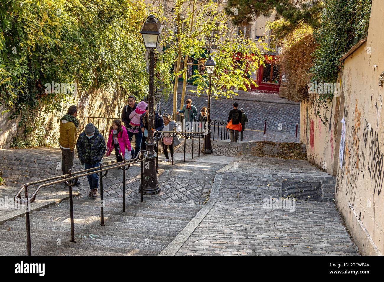 People walking up thesteep steps of Calvaire Street Stairs, Escaliers ...