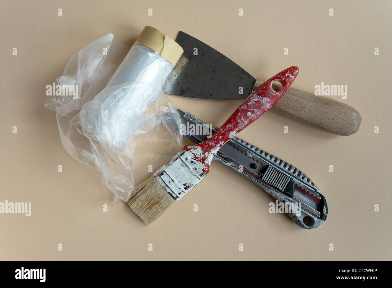 A set of painter's tools. a paint brush, a spatula and a knife for the ...