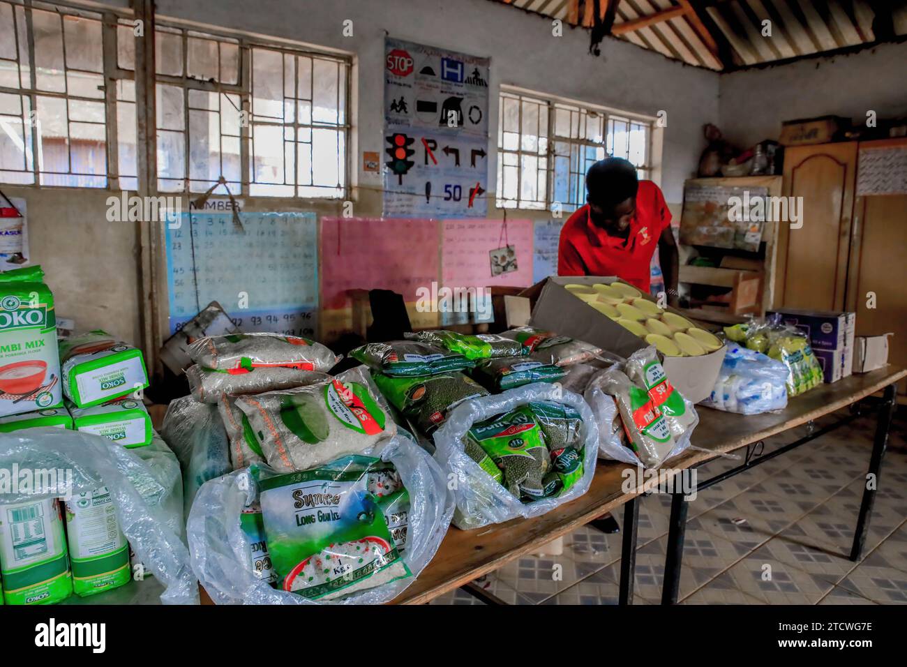 Volunteers at Family Care Mission arranging food packages during their ...