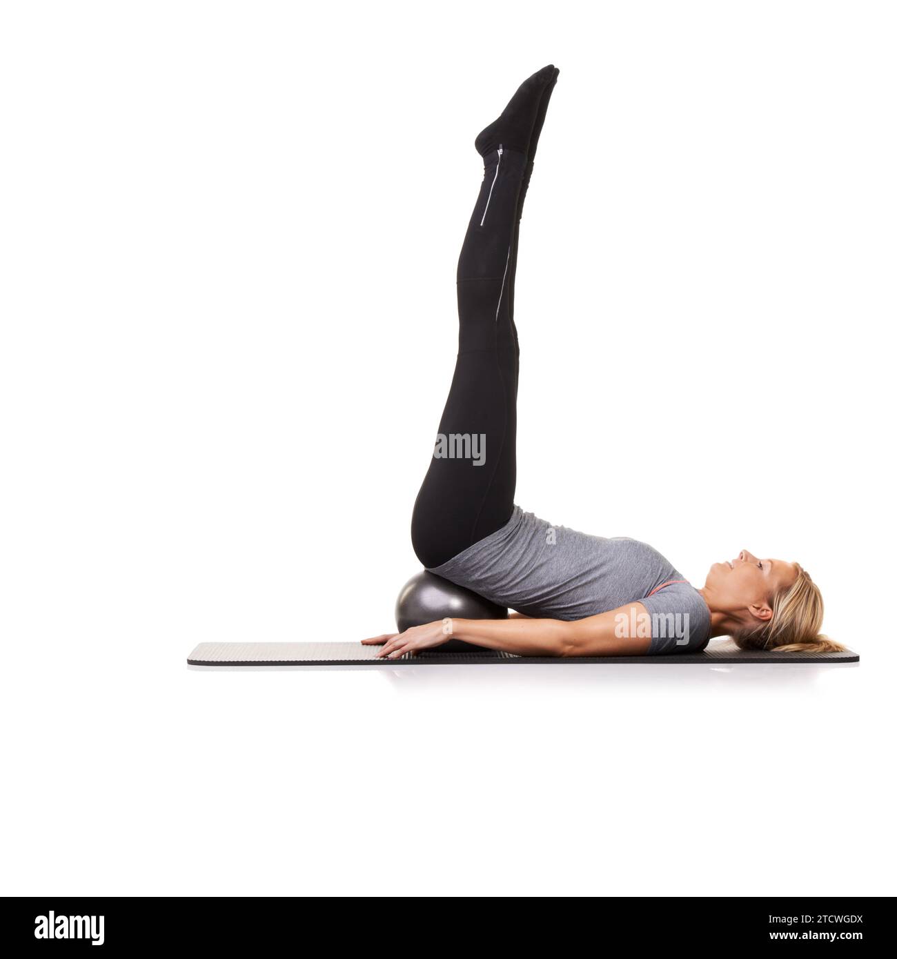 Woman, exercise ball and back balance on yoga mat for workout ...