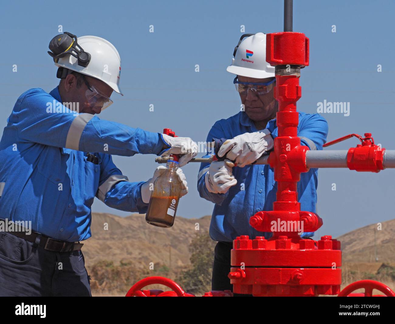 Petroperu personnel extracting a sample of crude from an oil well that ...