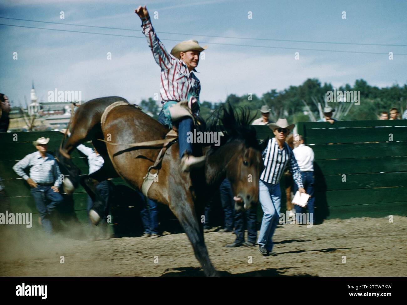 EUGENE, OR - SEPTEMBER, 1958: An unidentified man rides a bronco during ...