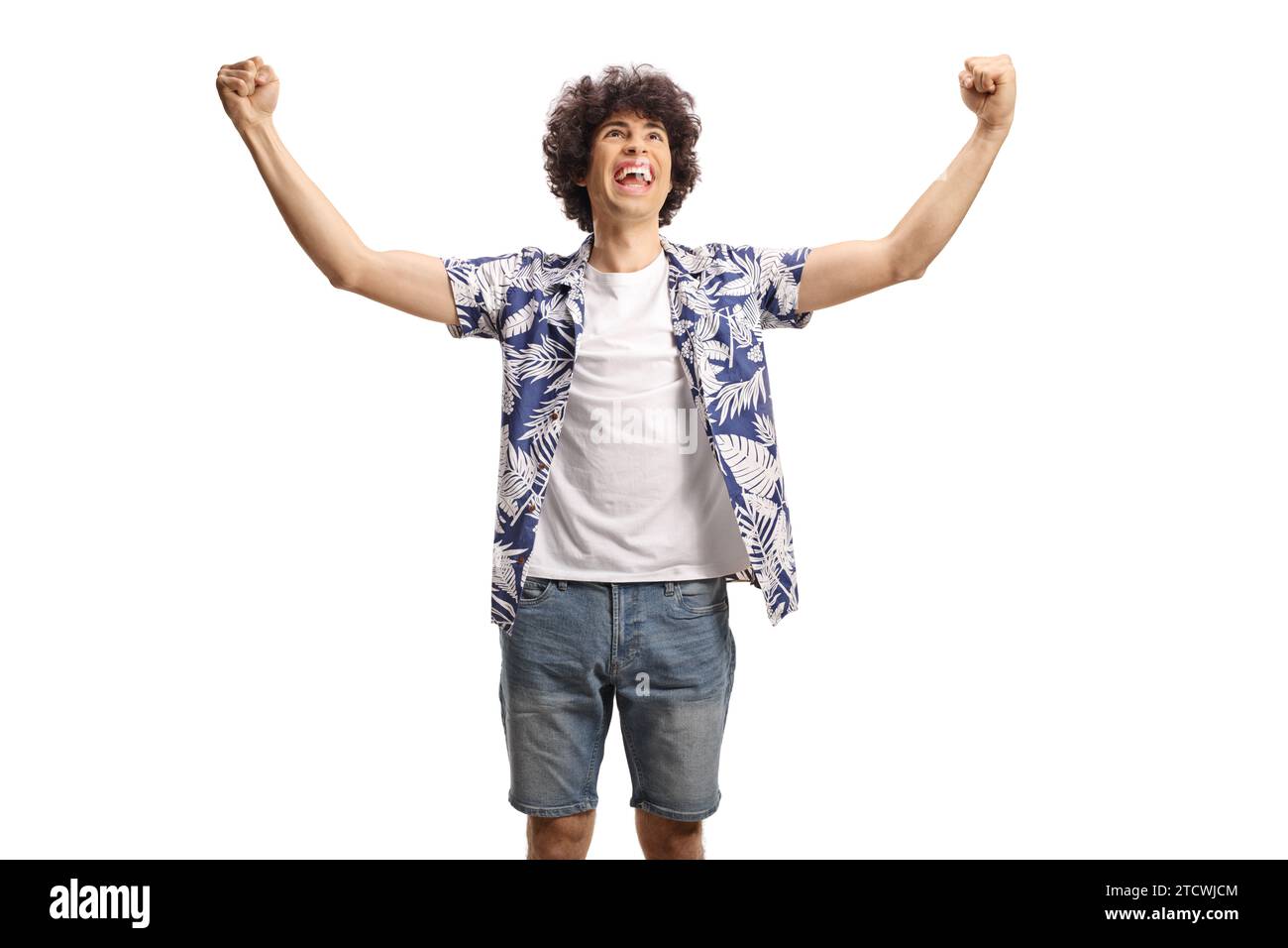 Overjoyed young man gesturing happiness with arms up isolated on white ...