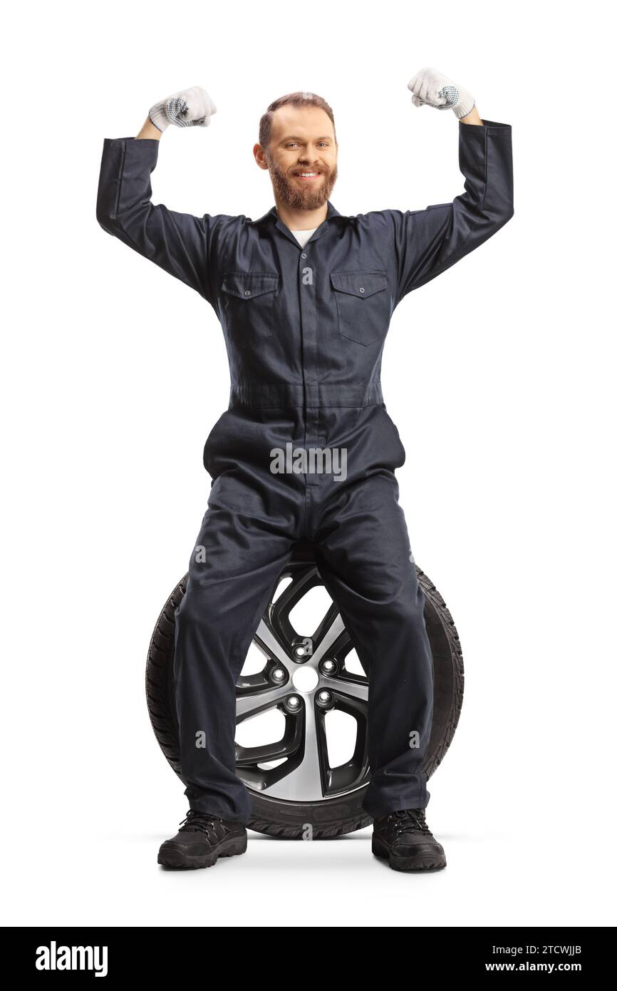 Strong car mechanic sitting on a tire isolated on white background ...