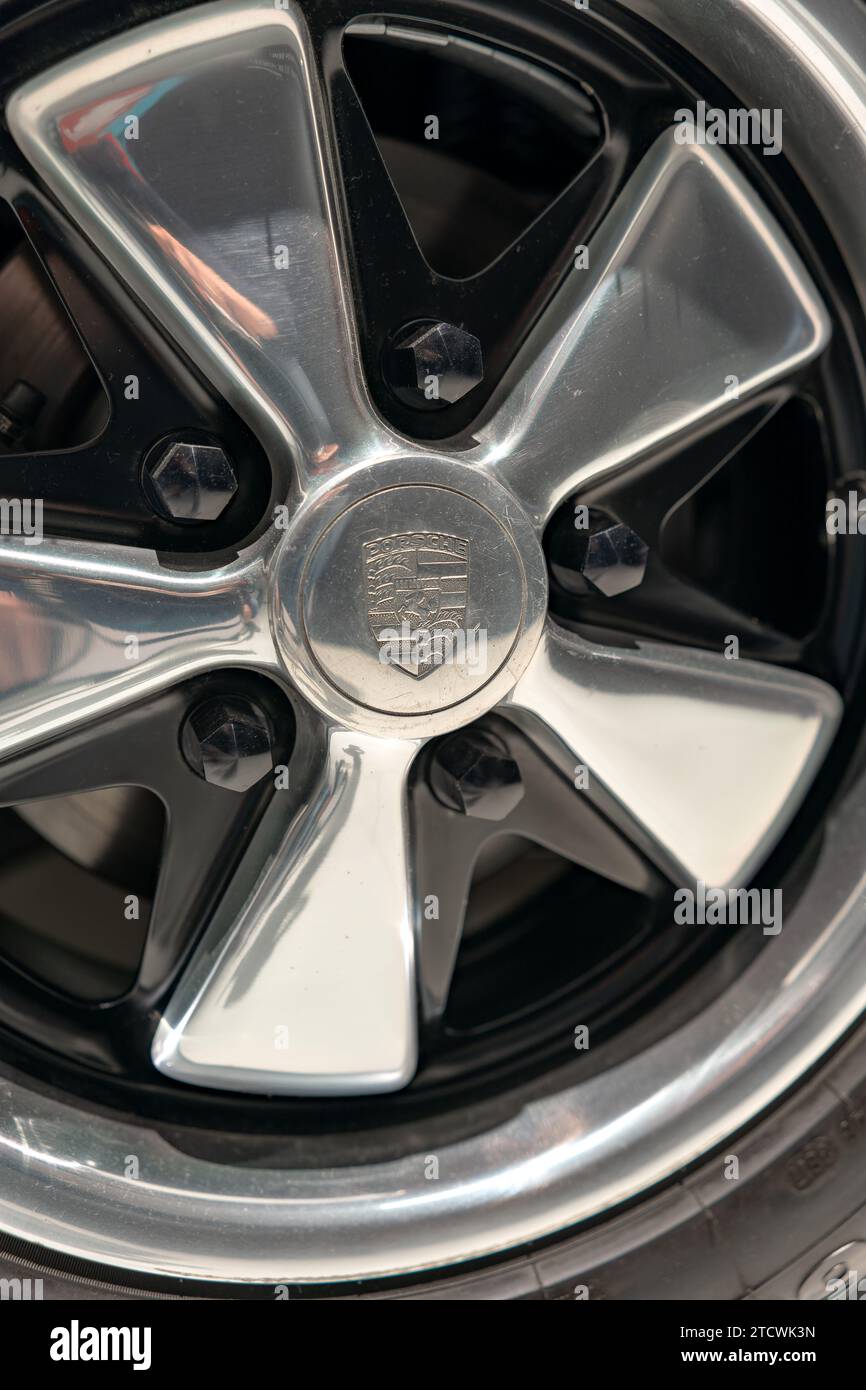 The Porsche logo is a close-up on the wheel of the car. Stuttgart ...