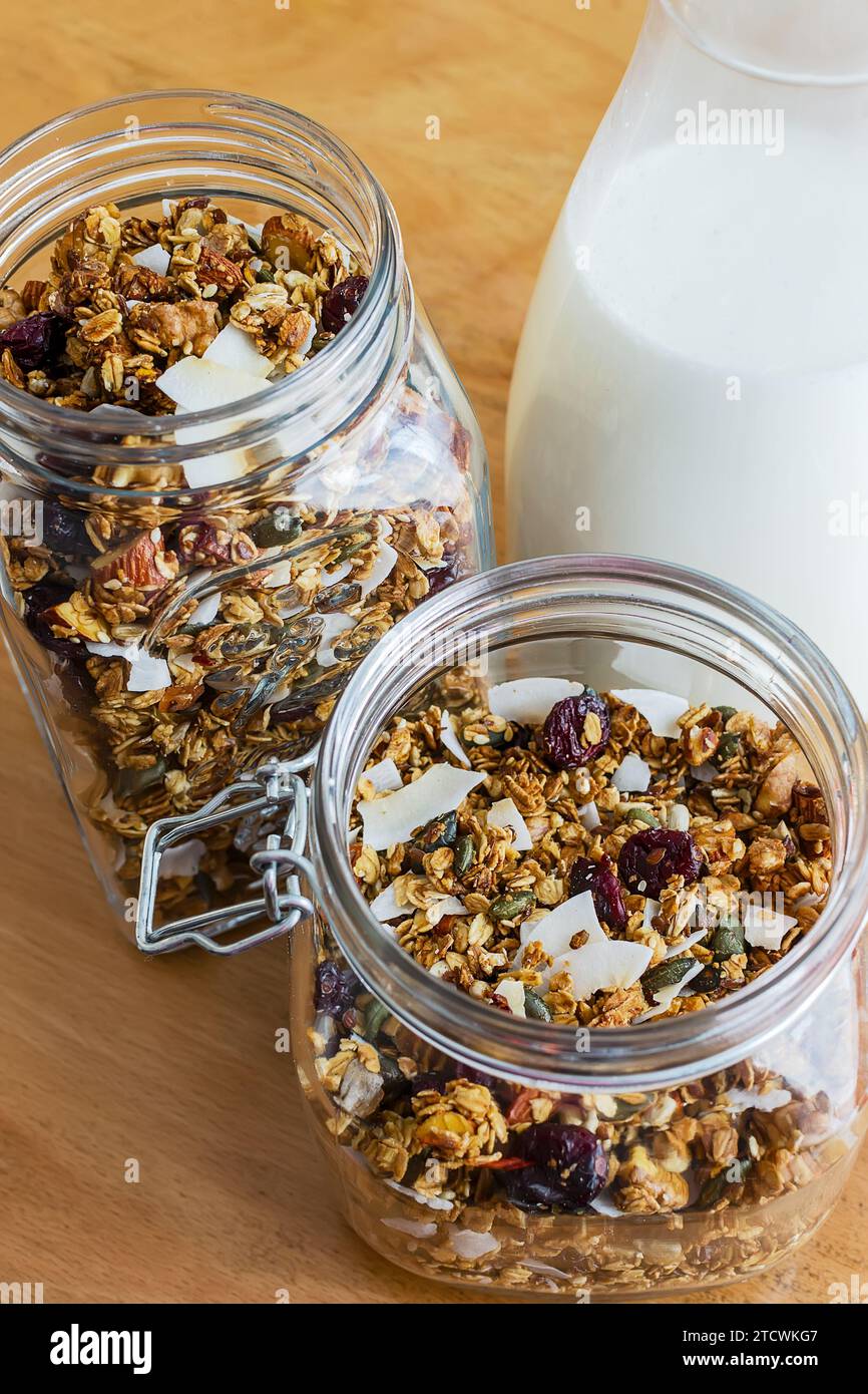 Homemade granola in open glass jar on rustic wooden background Stock Photo - Alamy