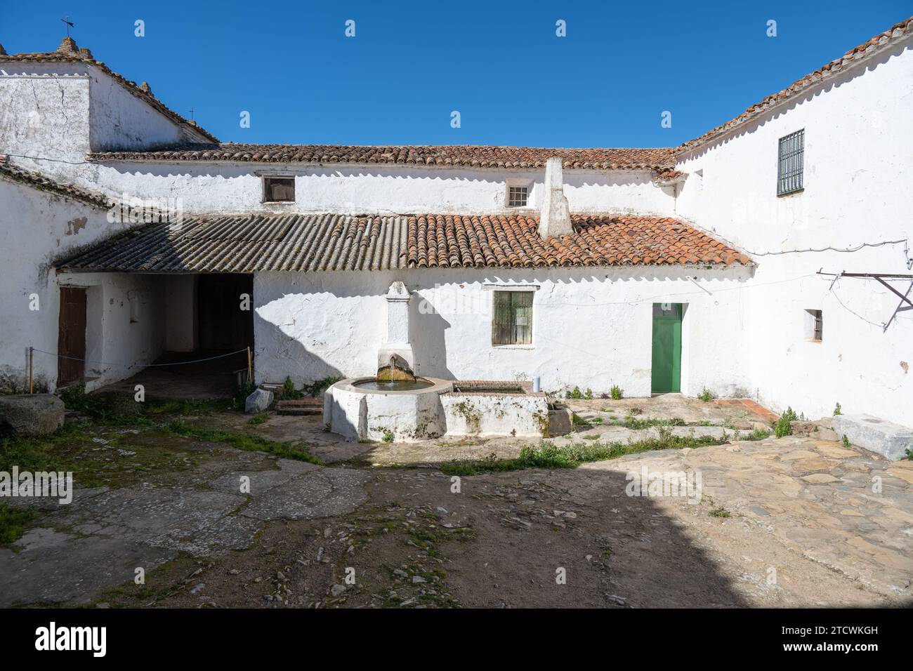 Traditional white rural buildings with terracotta tiled roofs under a ...