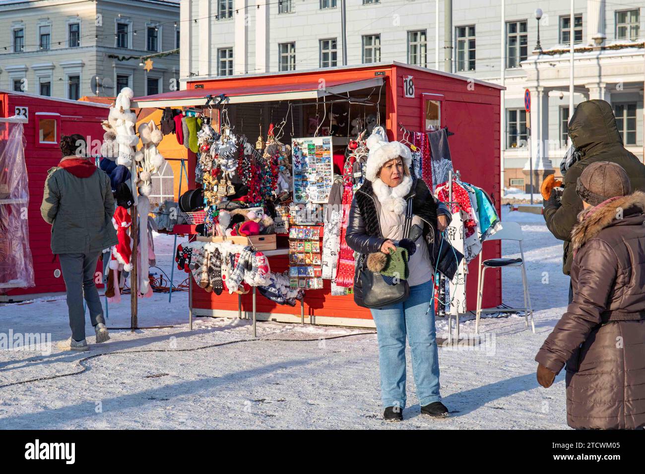 People on snow covered Market Square on a sunny winter day in Helsinki ...