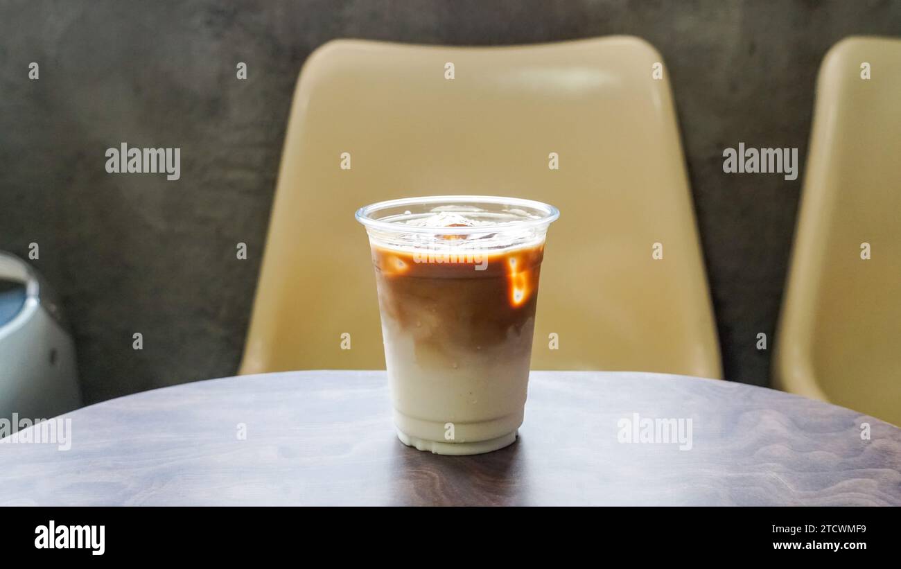 Iced Coffee with Milk in Tall Glasses on wood table Background. Concept ...