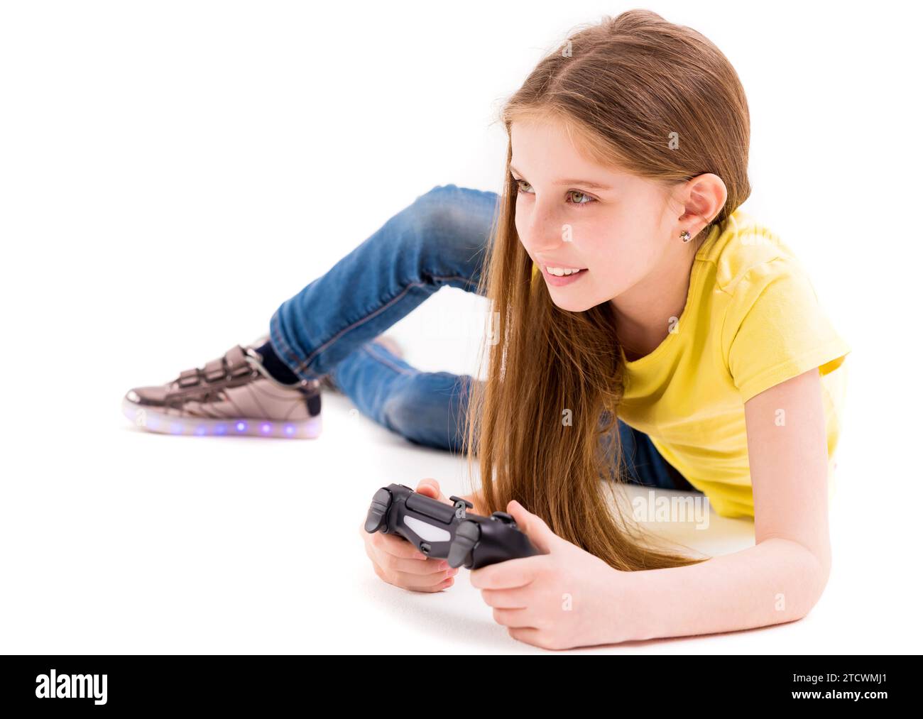 Concentrated and focused on winning a computer game girl, lying with a ...