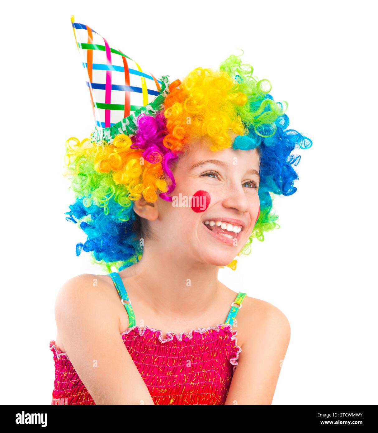 Funny little girl in clown wig with red spots on her cheeks isolated on ...