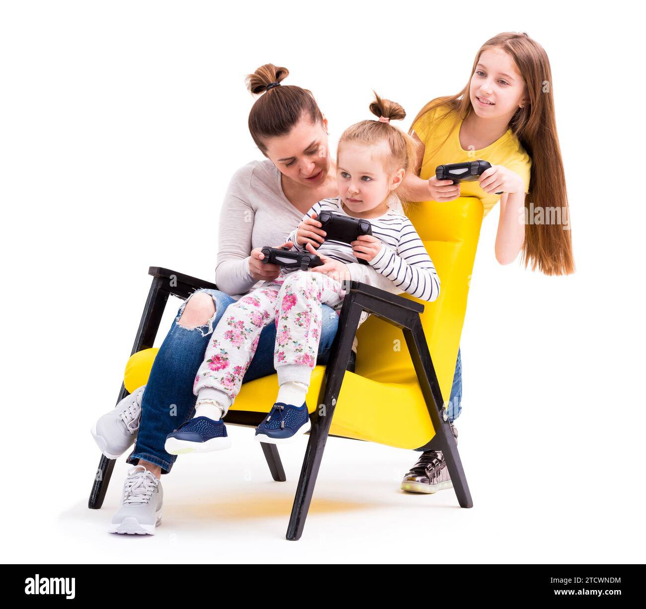 Family of three on leather yellow chair enjoying their time playing ...