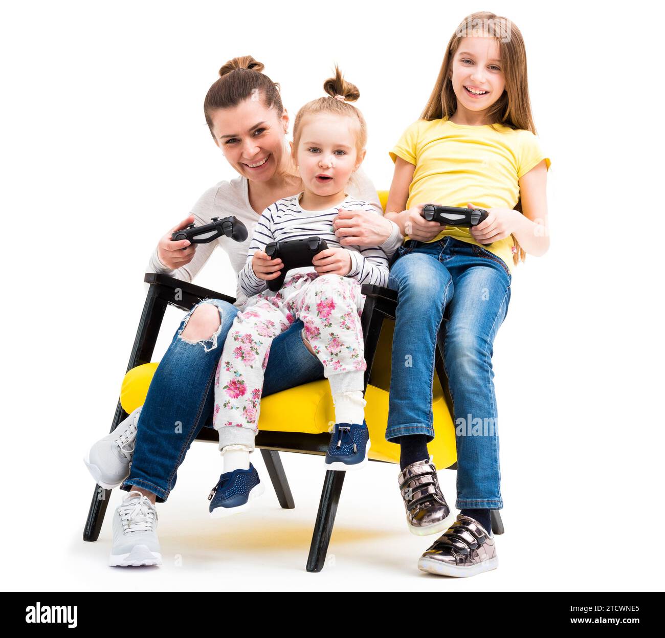 Mom and daughters spending time on computer games on playing console ...