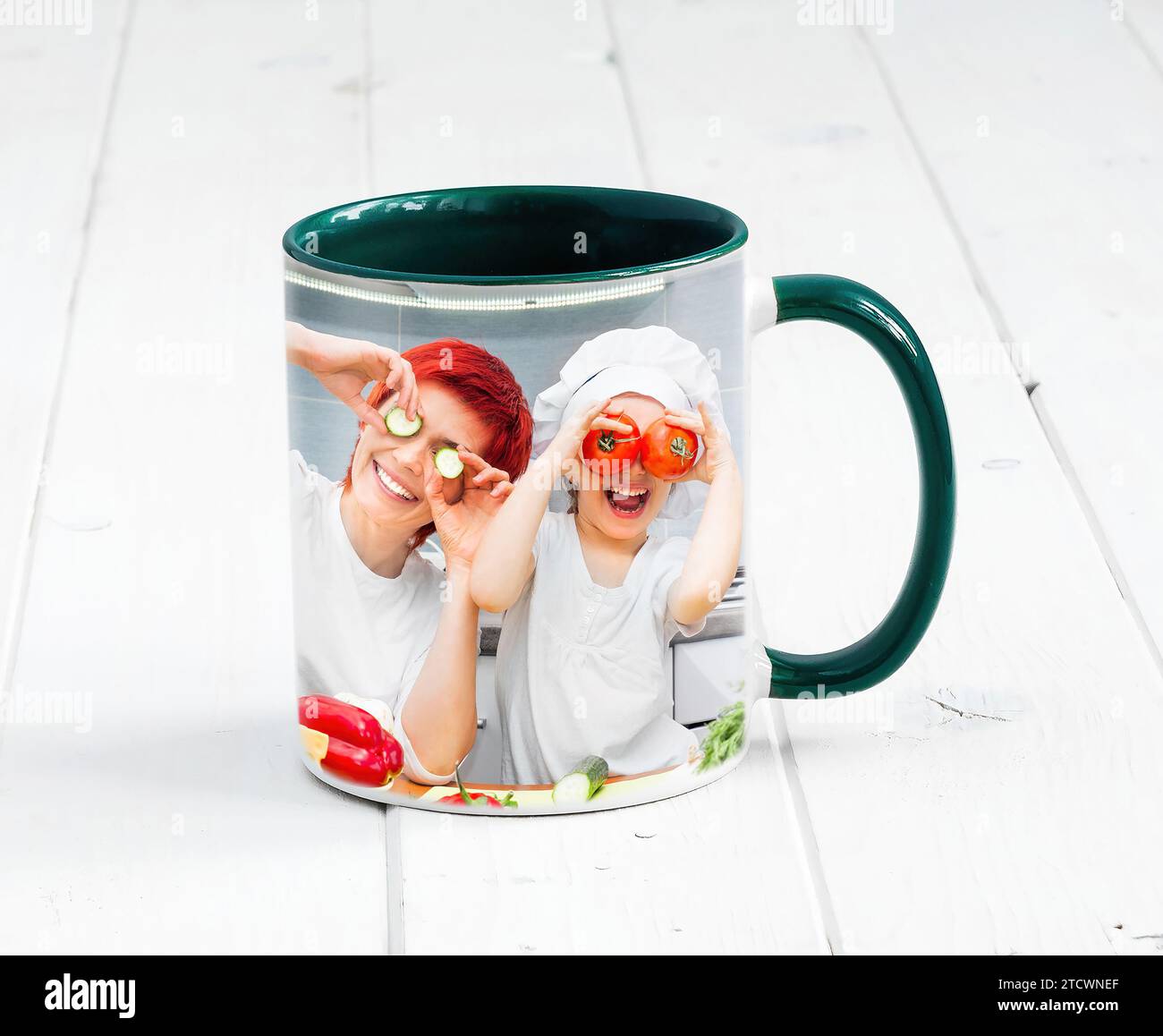 Big green cup with dark green handle and print of a kids cooking ...