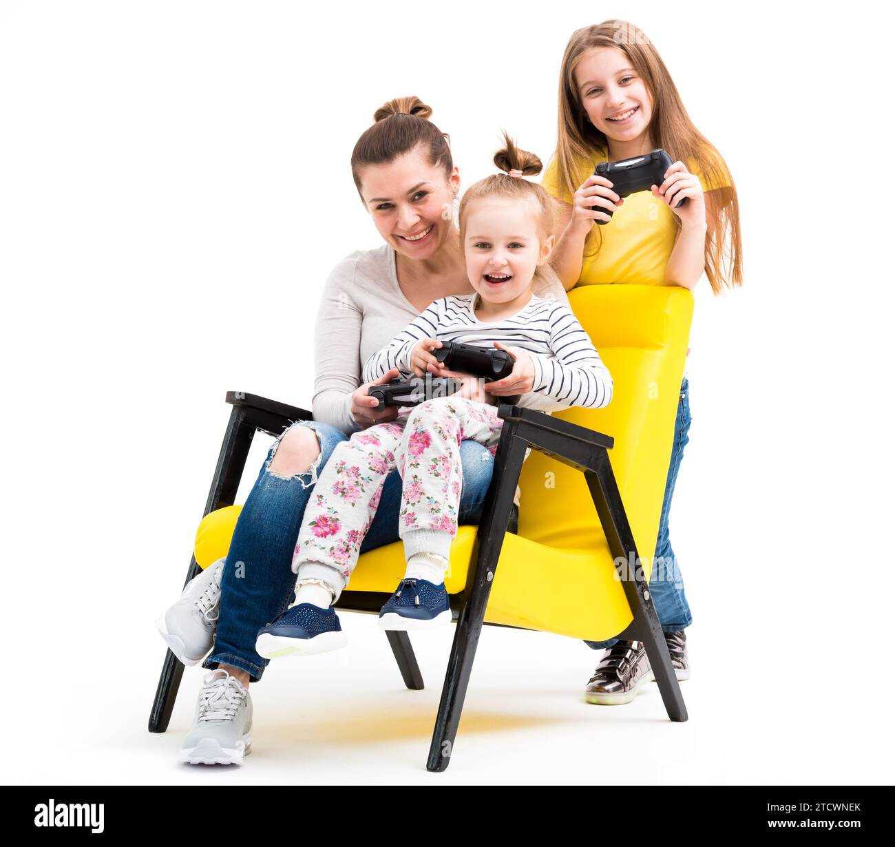 Family of three on leather yellow chair enjoying their time playing ...