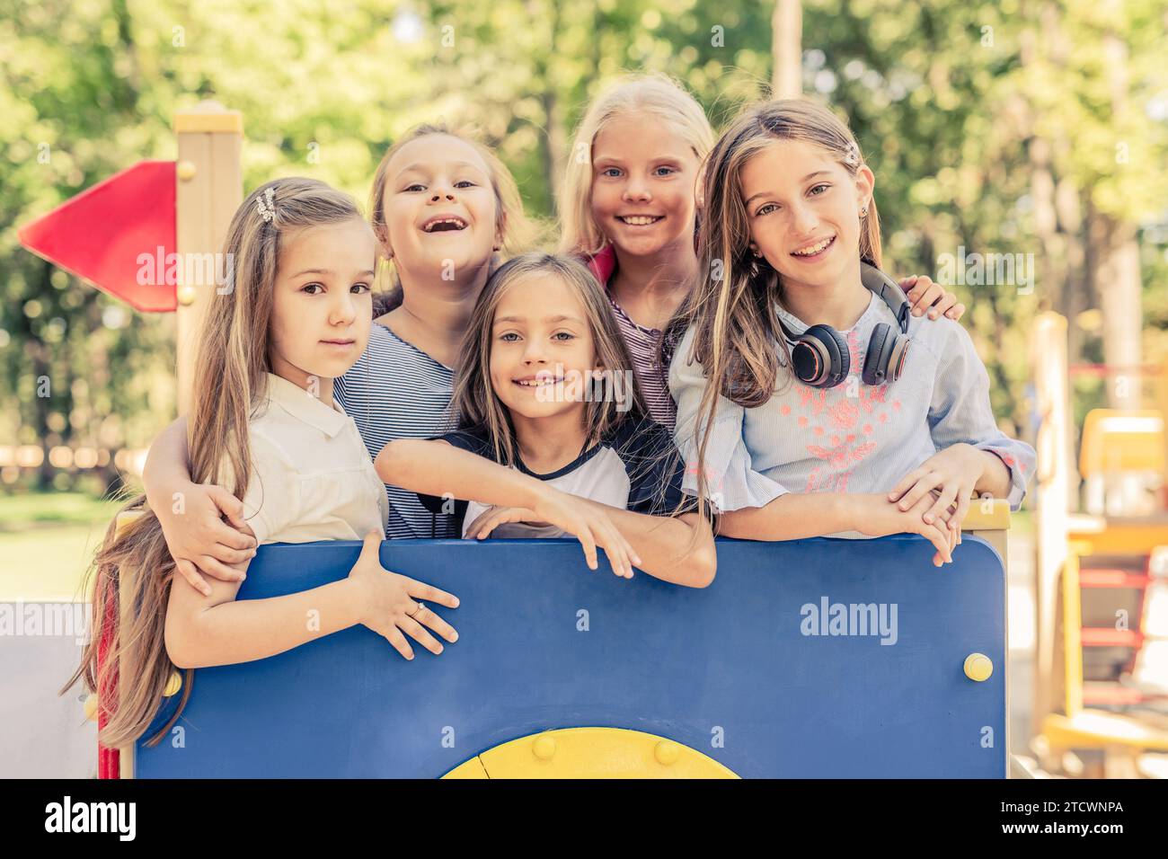 Smiling Kids standing together on the playground Stock Photo - Alamy