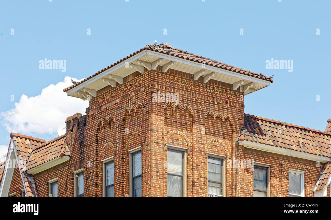 Deep eaves and tile roof cap the square corner tower of 32-65 80th ...