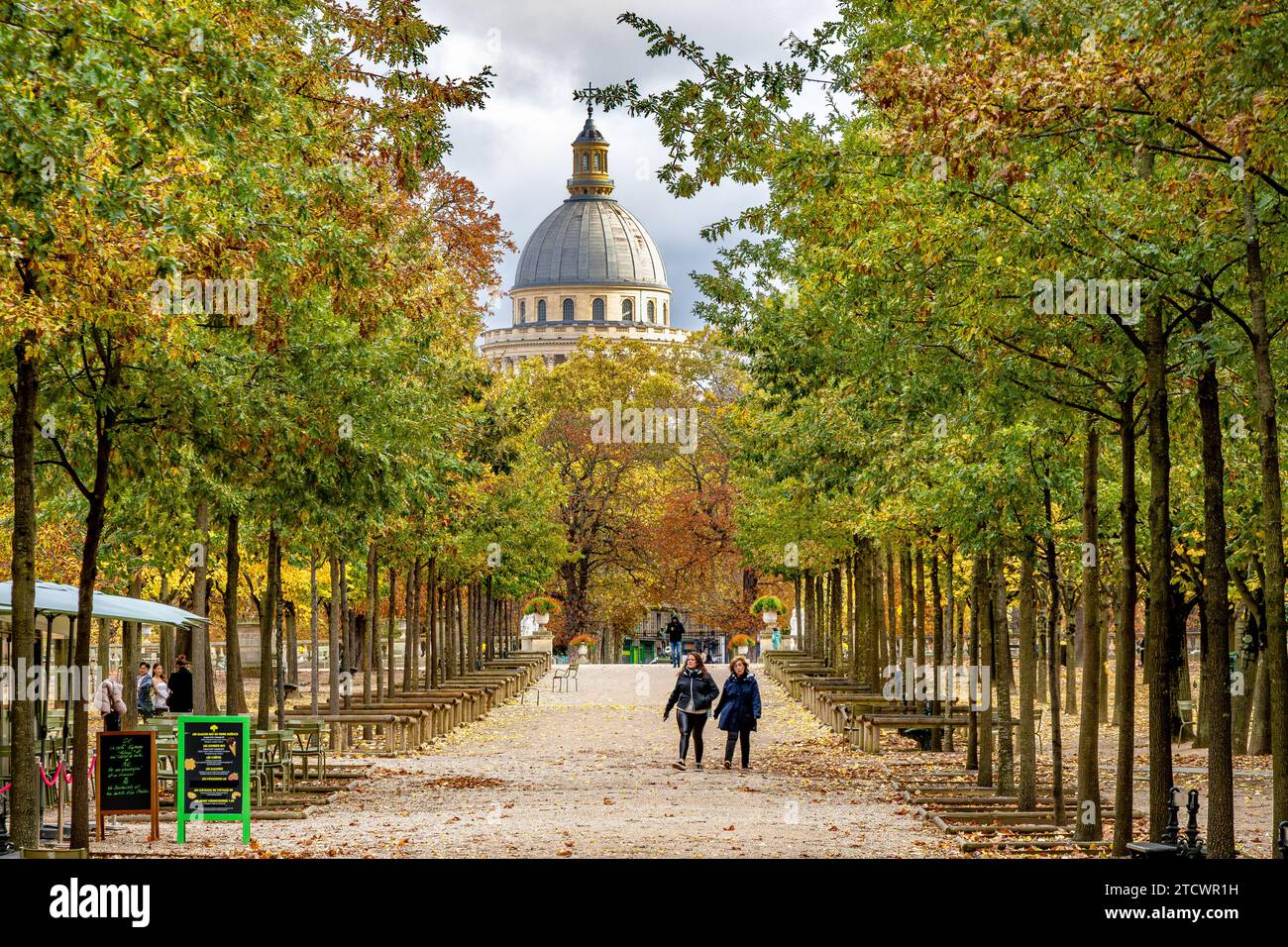 Two woman walking along a tree lined path in the autumn at The Jardin ...